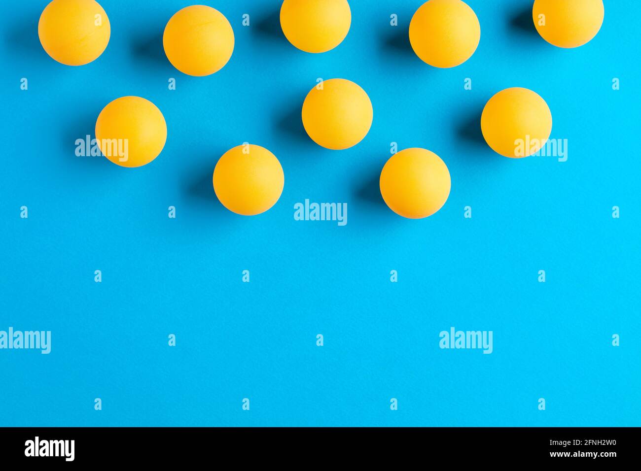 Orange table tennis or ping pong balls on blue background with copy ...