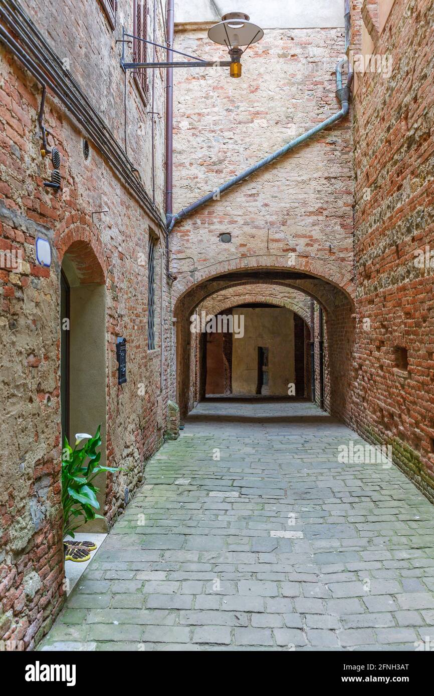 Old alley with brick walls Stock Photo - Alamy