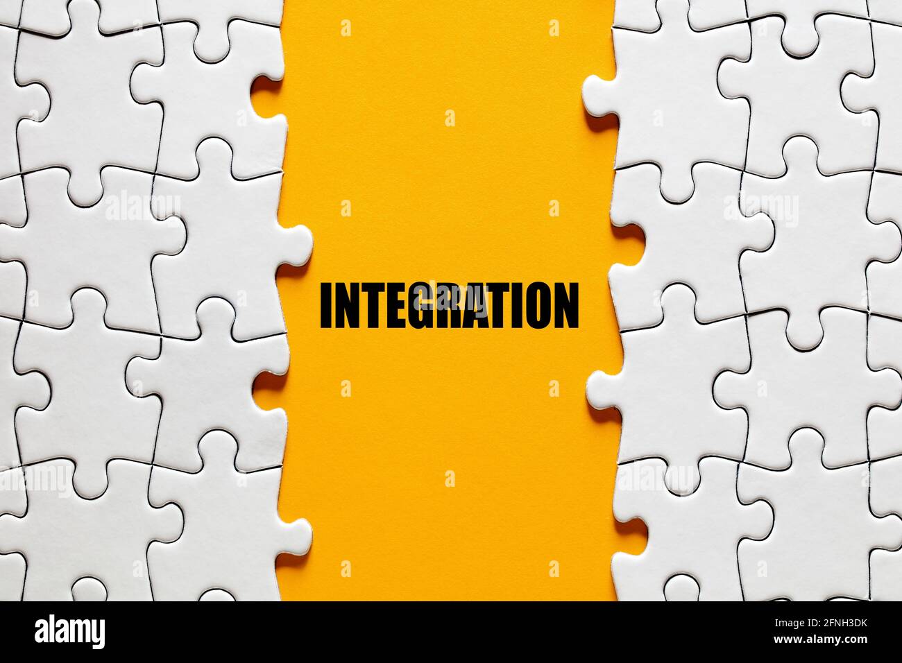 The word integration on yellow background between the jigsaw puzzle ...
