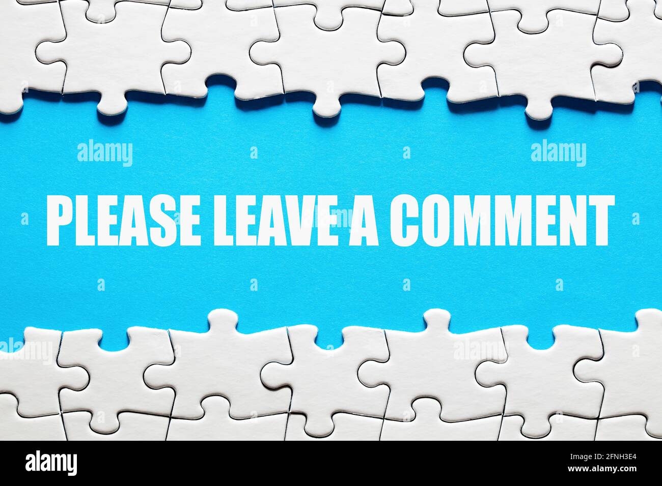 Please leave a comment message on blue background framed by jigsaw ...