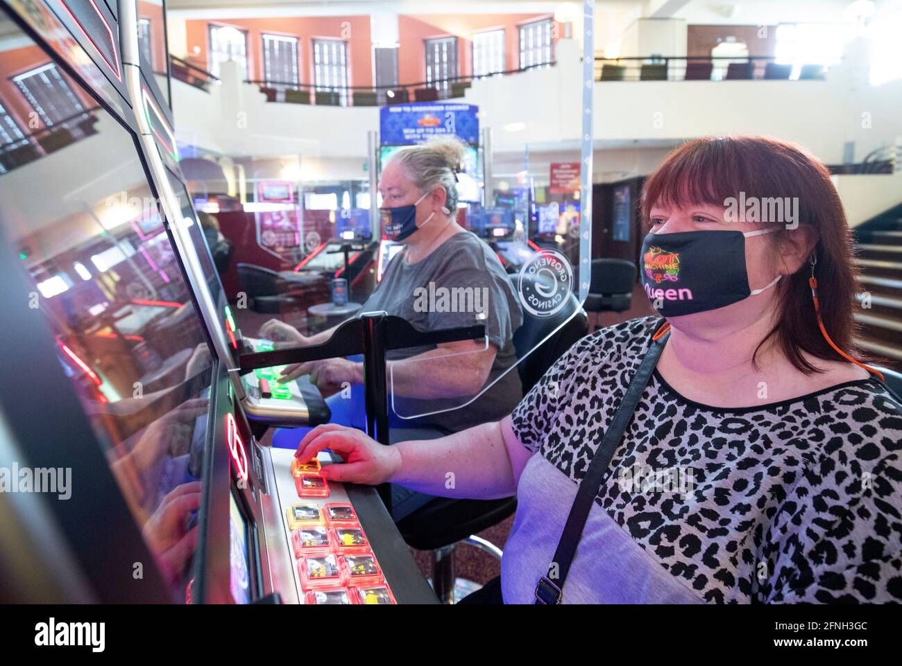 Customers Belinda Jamieson (right) and Elaine Banks play the slot ...