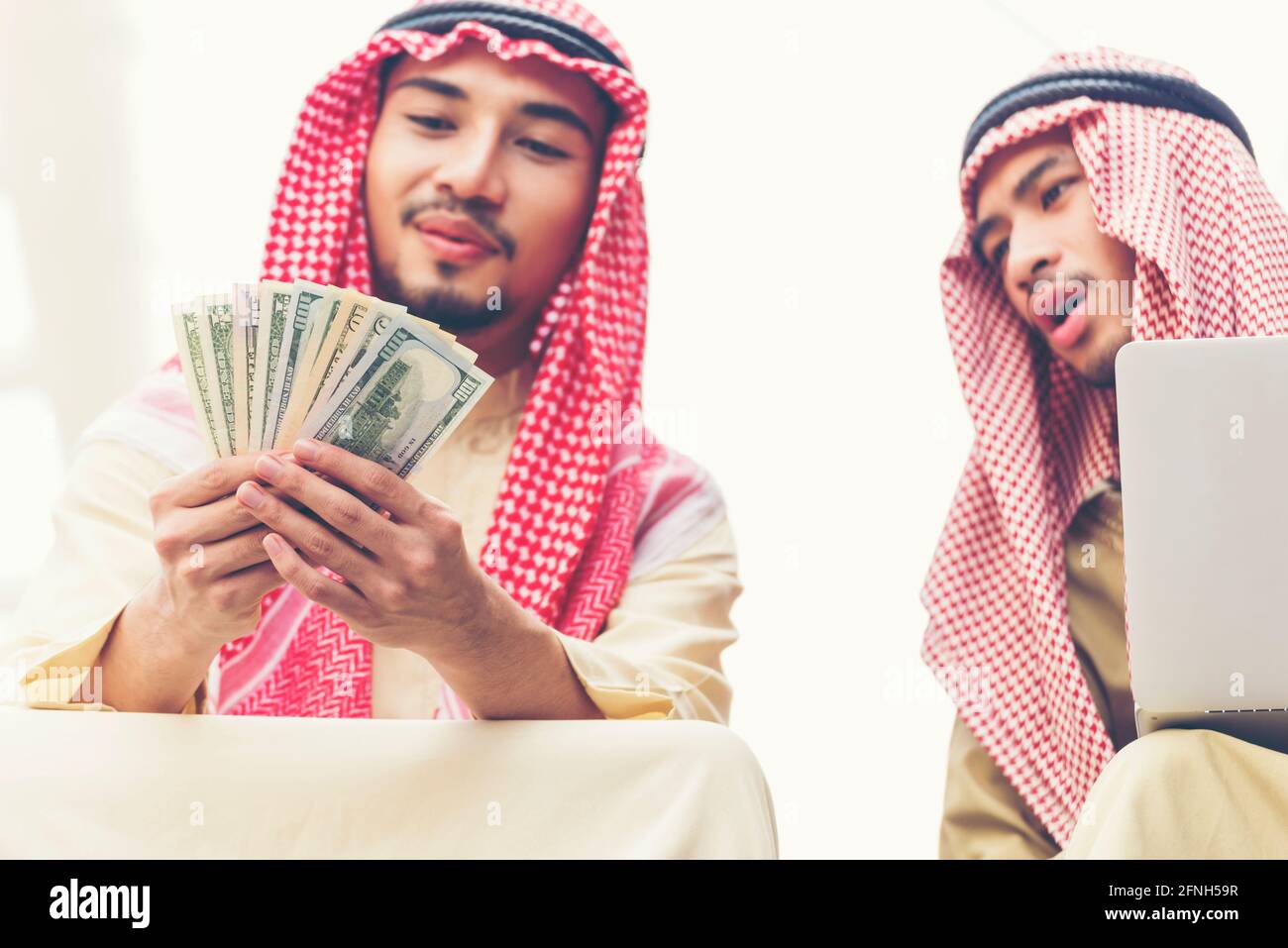 Handsome greedy arab man showing money on hands and counting money ...