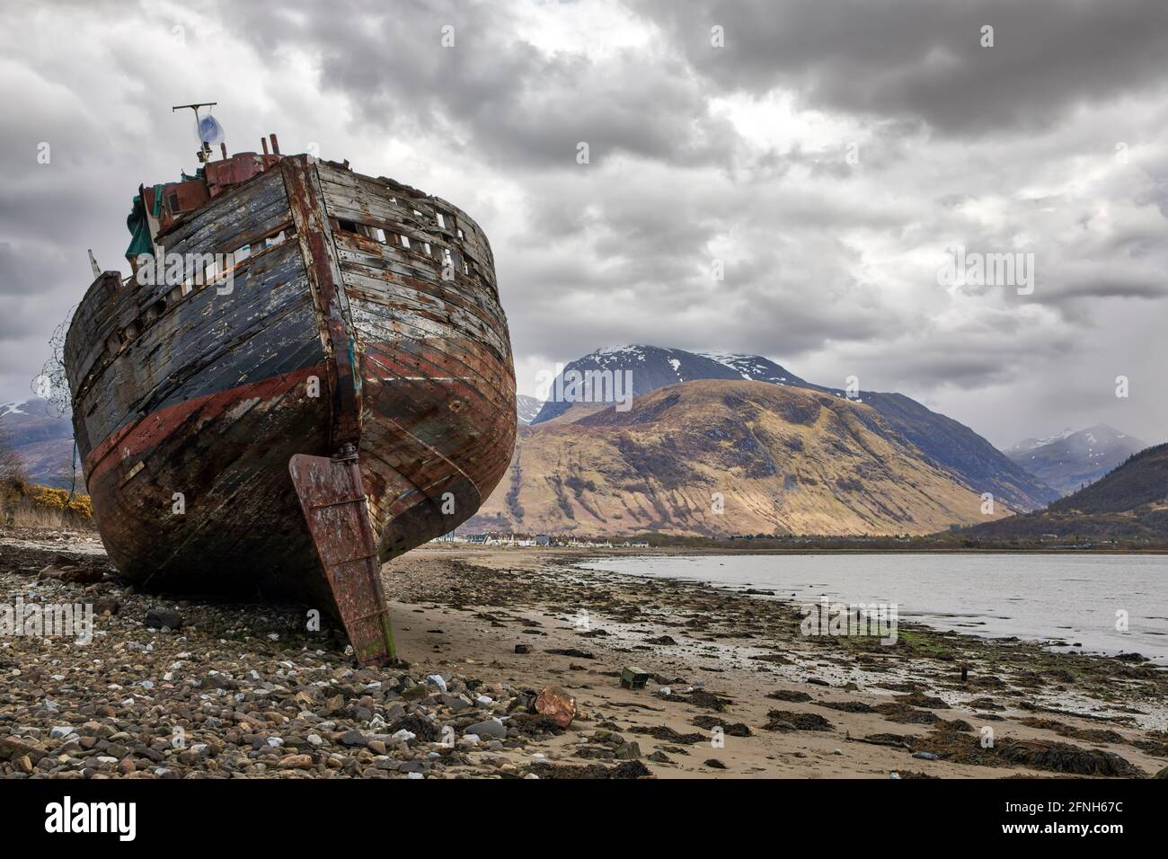 ship wreck on Loch Linnhe shore at Corpach Scotland with Ben Nevis in ...