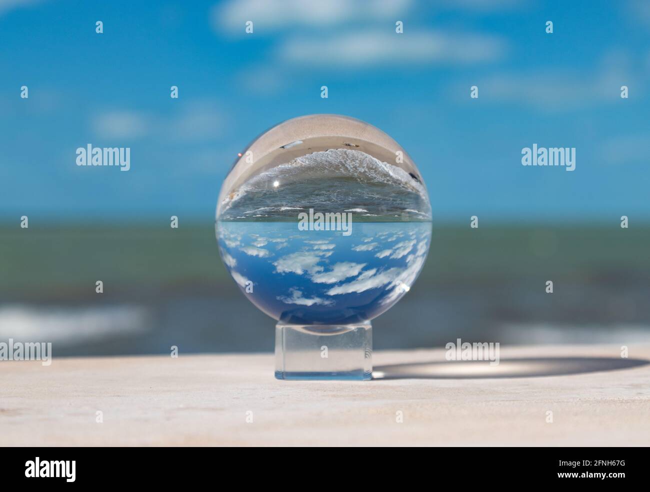Calm ocean and bright blue sky reflected in a crystal ball Stock Photo ...