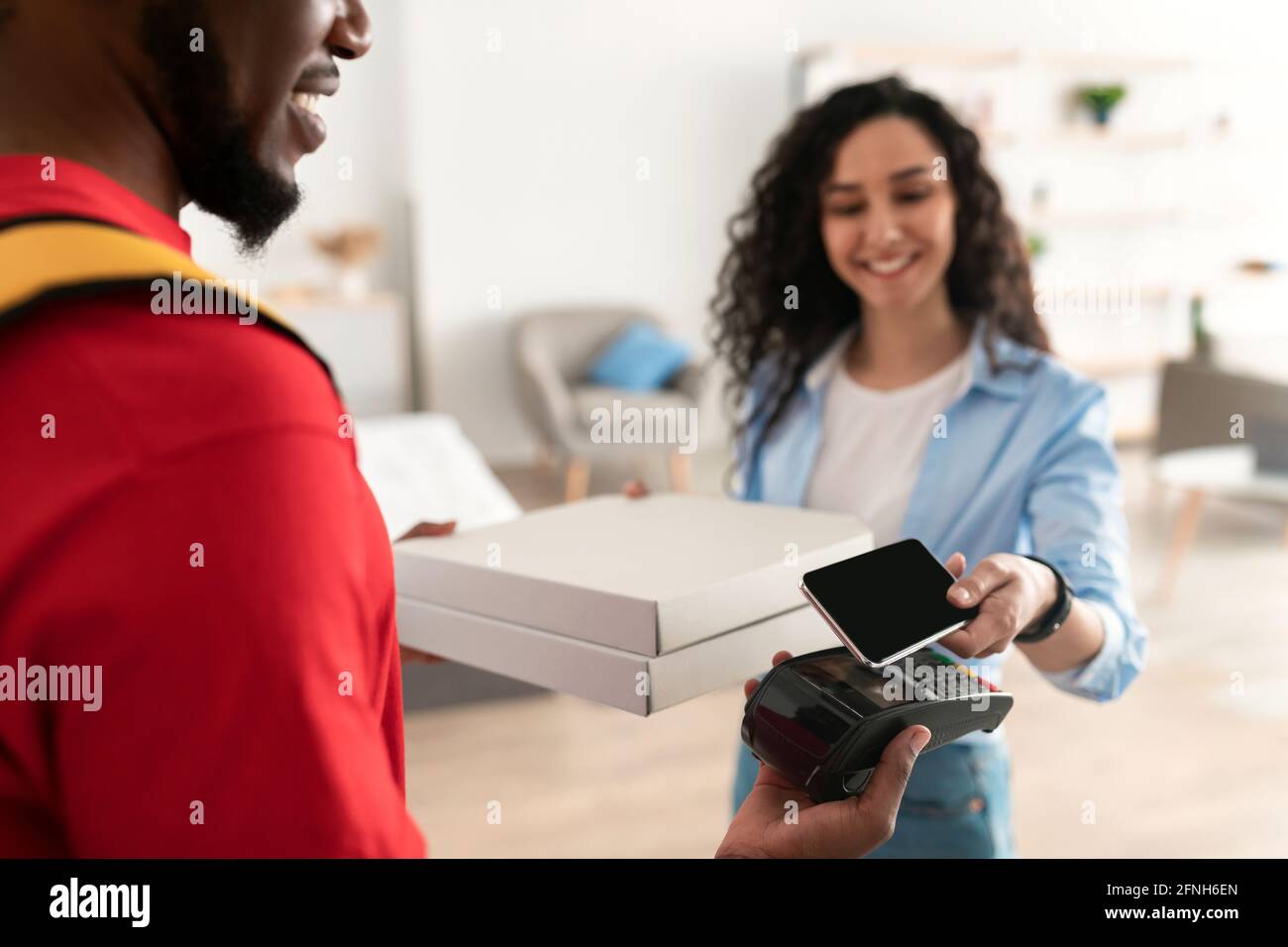 Black man transaction mobile phone hi-res stock photography and images ...