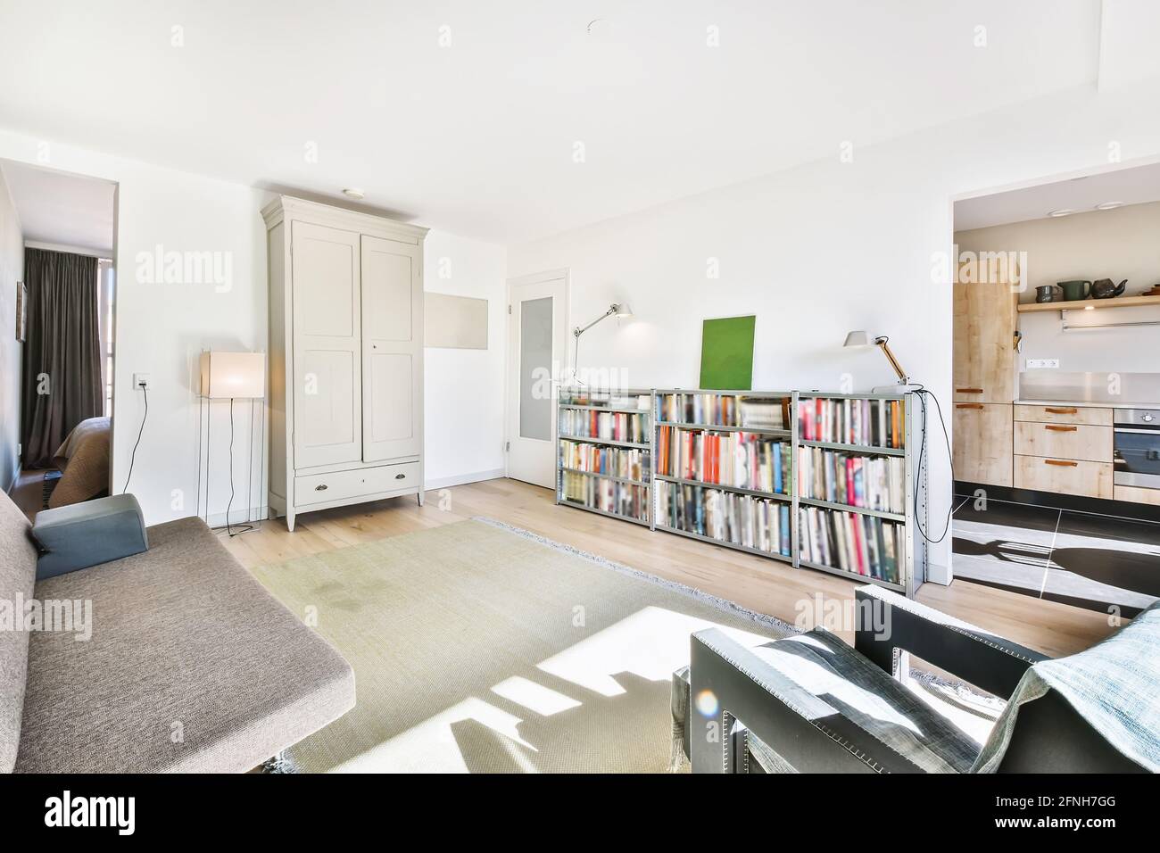 Living room with bookshelf and wardrobe Stock Photo - Alamy