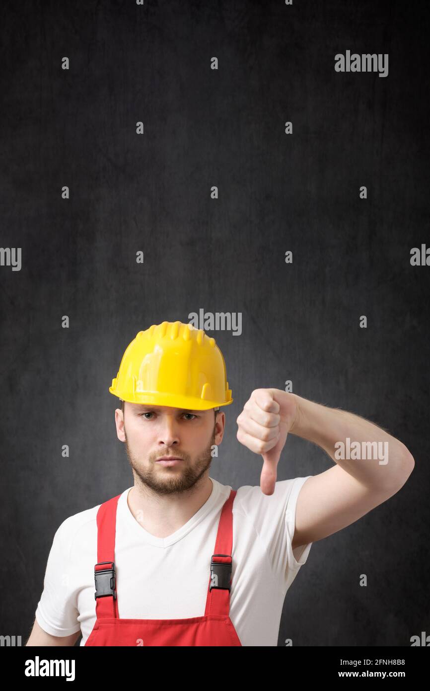 Unhappy construction worker Stock Photo - Alamy