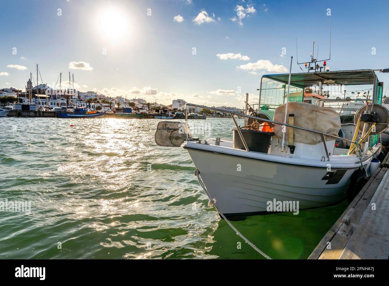 Boats in marina of Lagos with the old town behind, Algarve, Portugal ...