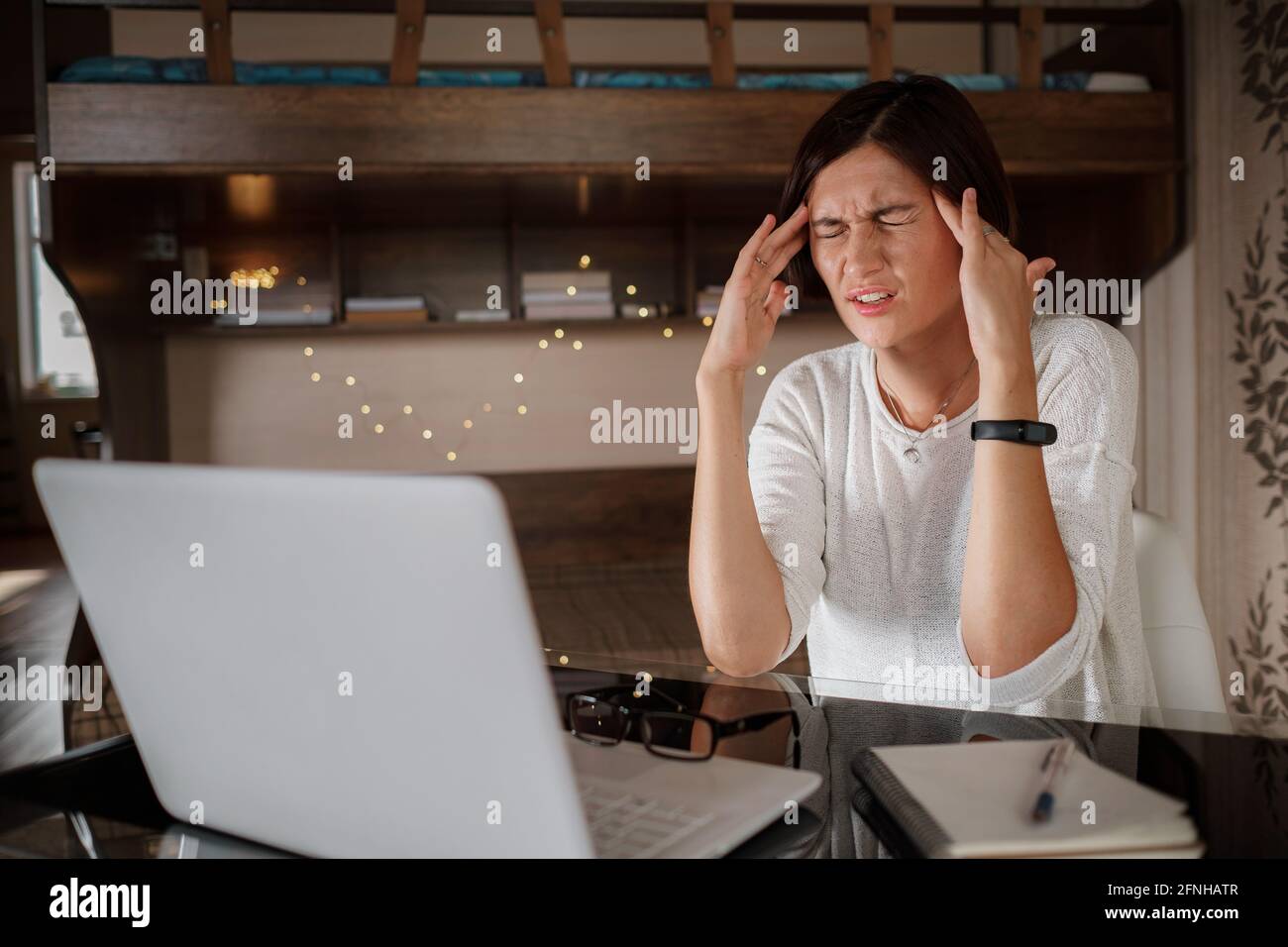 Upset asian woman working from home office. Unhappy freelancer using laptop and the Internet ...