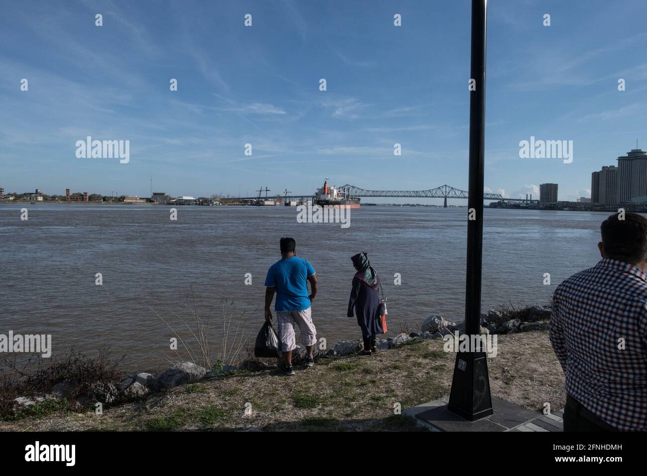 People watch as a massive MSC container ship carrying global cargo ...
