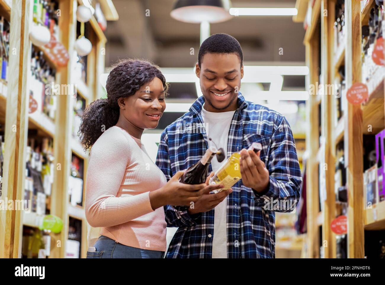 Couple holding wine bottle hi-res stock photography and images - Alamy