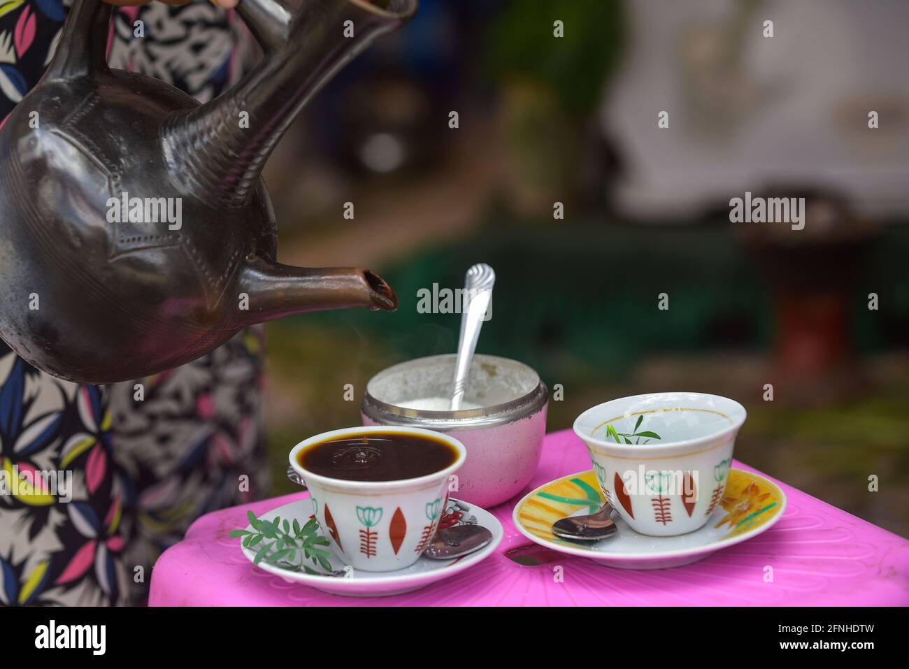 Addis Ababa. 14th May, 2021. A coffee vender serves traditional coffee ...