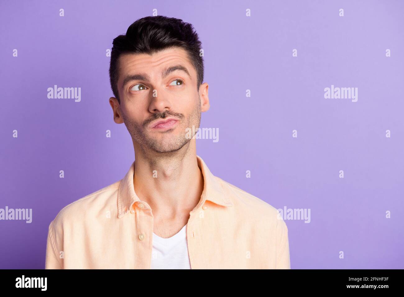Portrait Of Thinking Brunet Hair Guy Look Empty Space Wear Peach Shirt