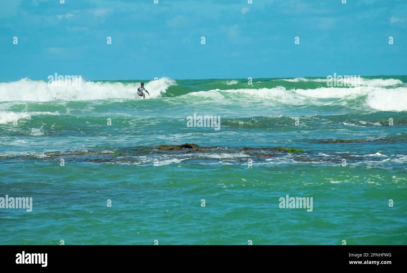 A man surfing in the reef breaks Stock Photo - Alamy