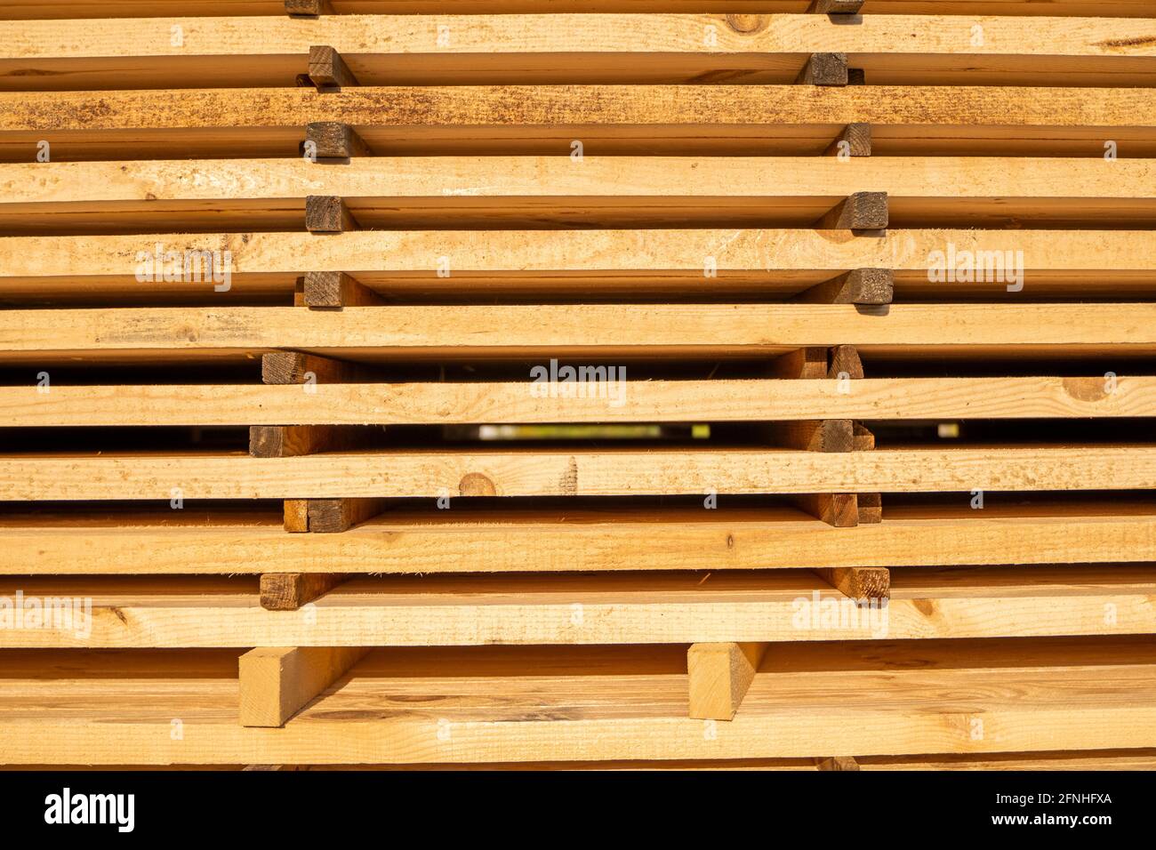 Storage of piles of wooden boards on the sawmill. Boards are stacked in ...