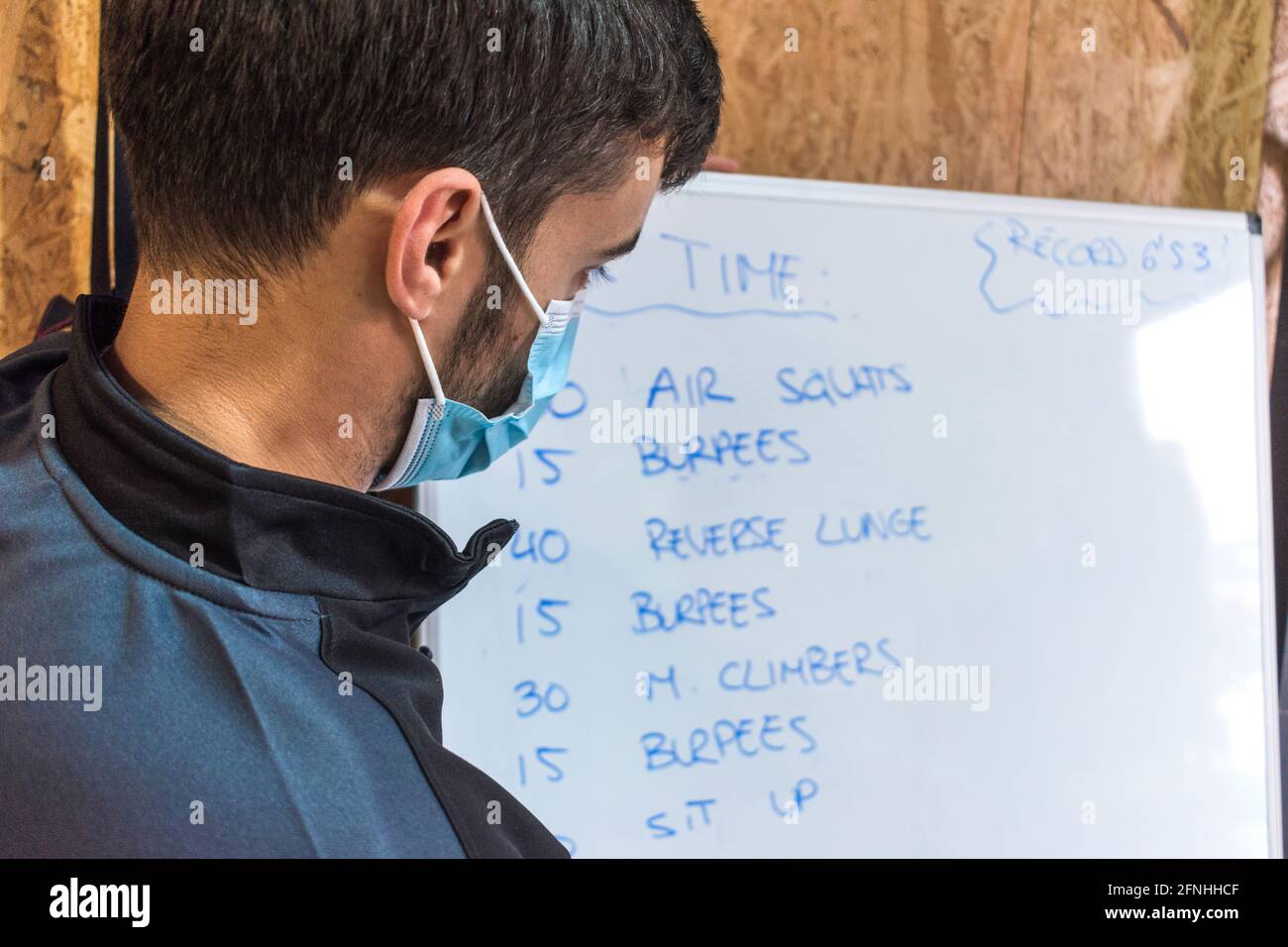 Personal trainer writing exercise chart on a whiteboard Stock Photo - Alamy