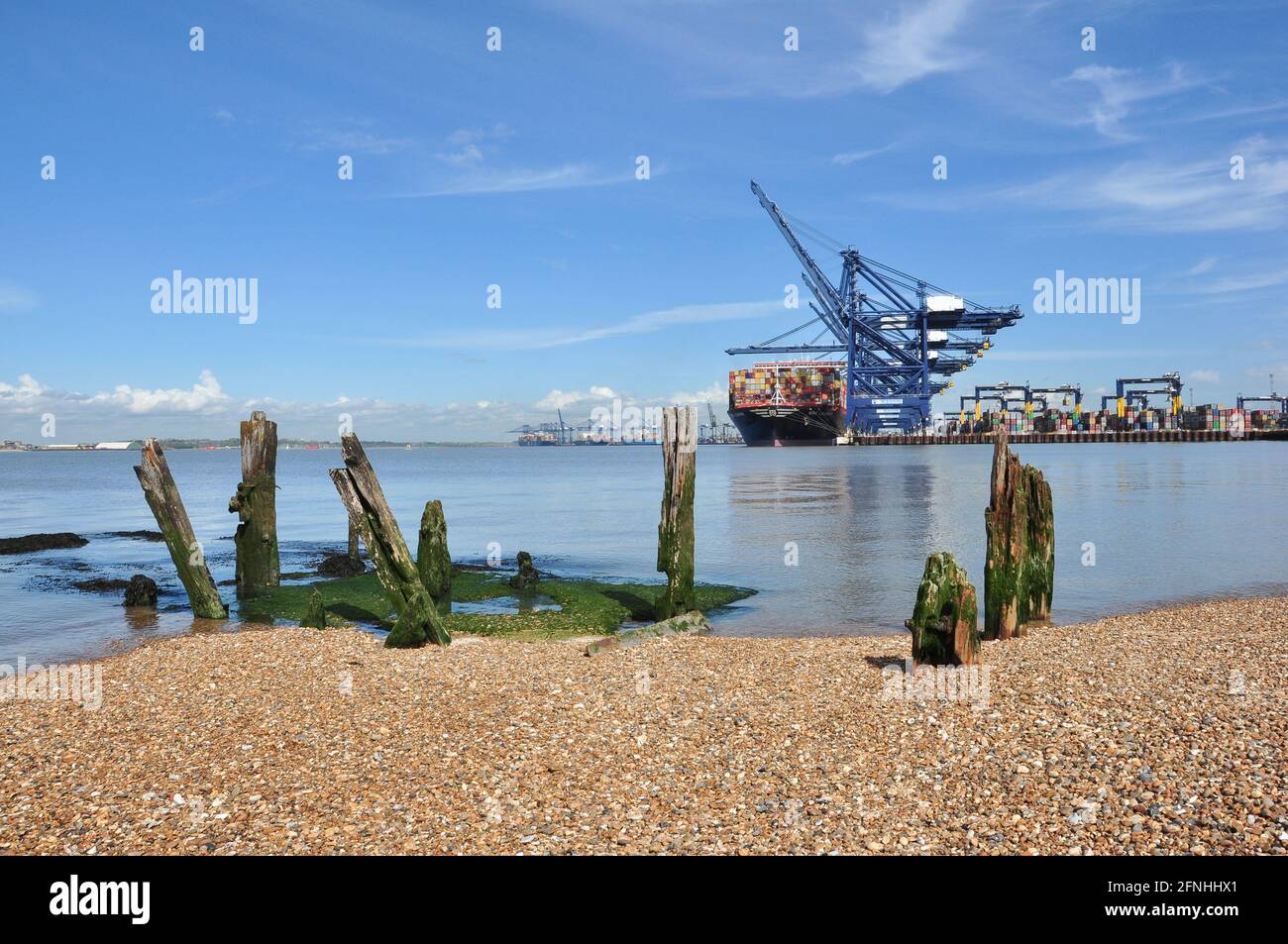 Old timber posts frame the Container ship MSC Leanne dockside at the ...
