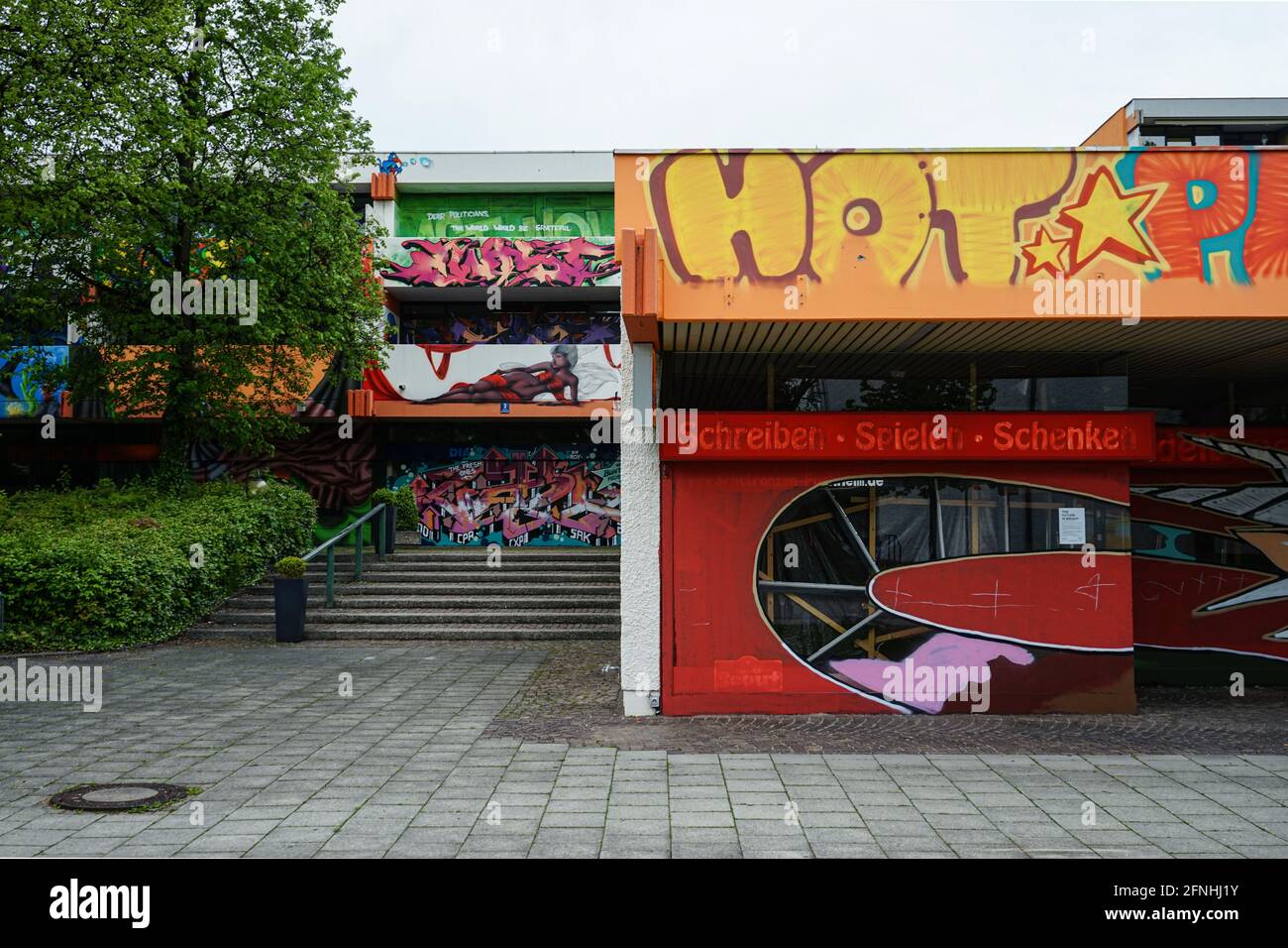 View from the street of the graffiti-covered facade of the demolition ...