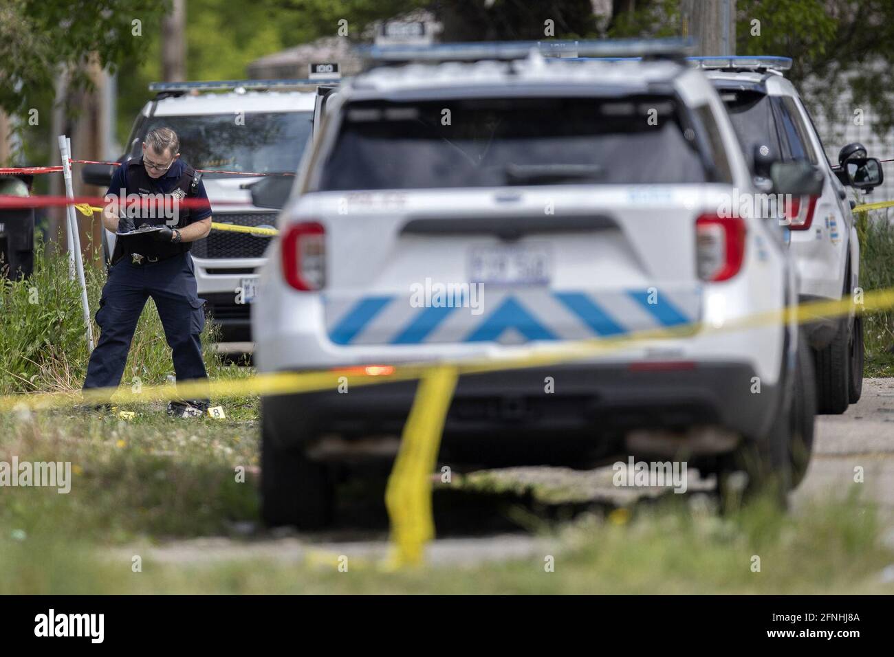 Chicago police officers work at the scene where two officers were shot ...