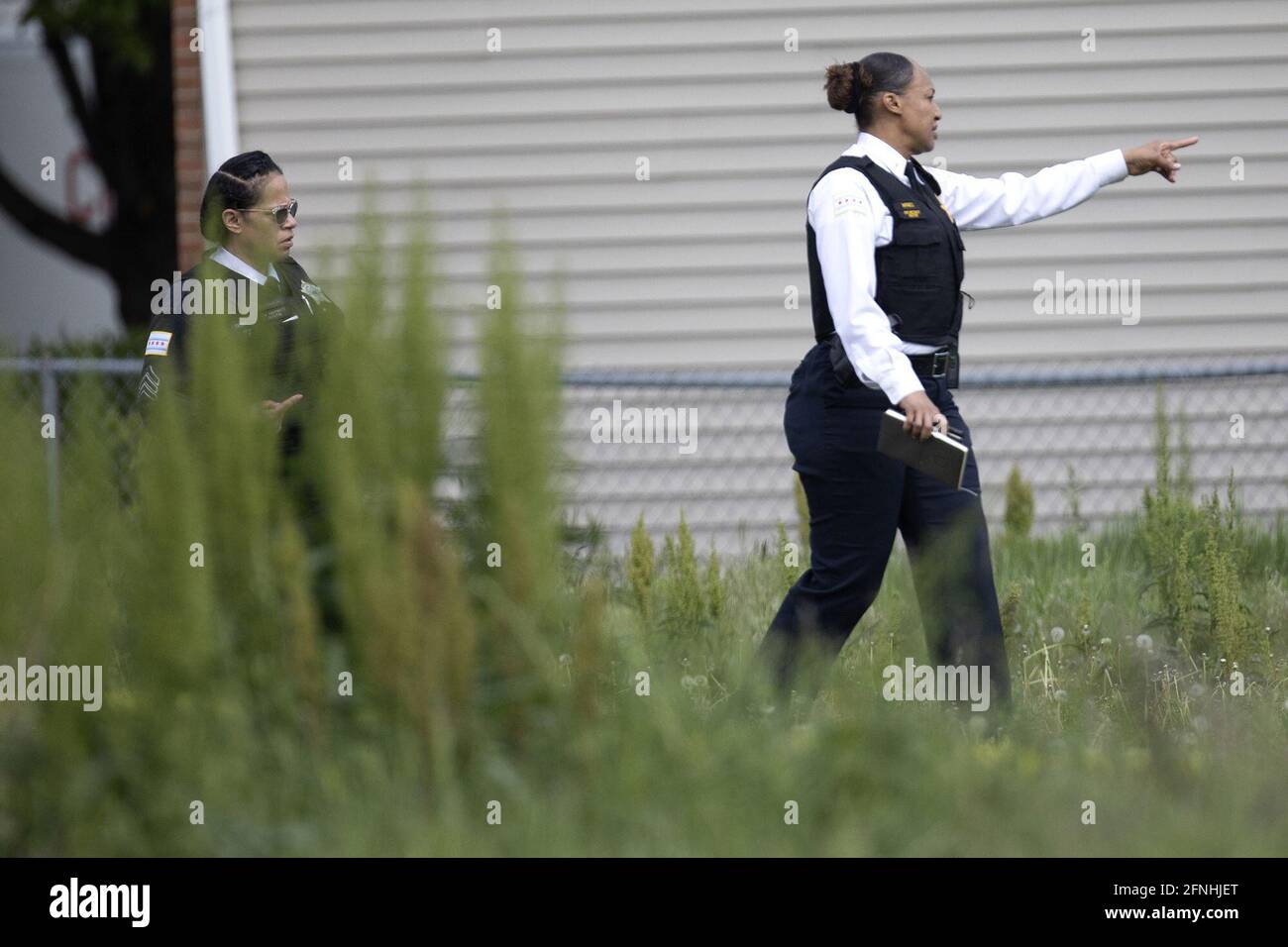 Chicago police officers work at the scene where two officers were shot ...