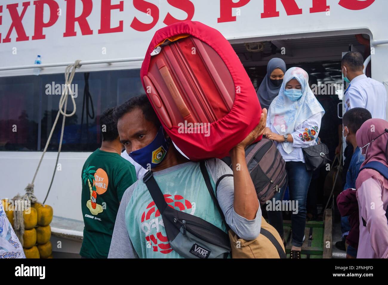 A coolie seen carrying his client's goods to get off the ship.The ...