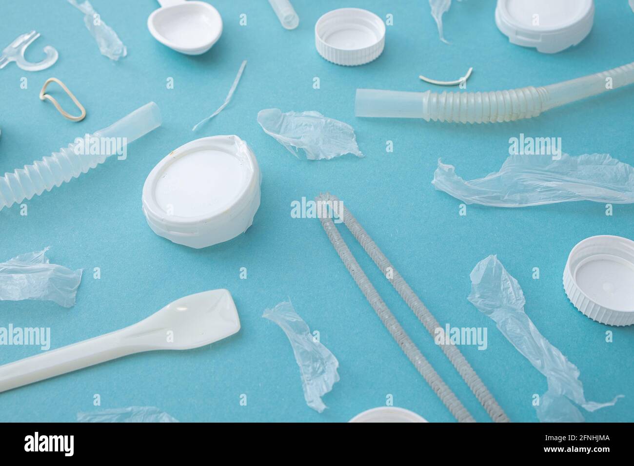 Idea with white single use plastic trash on blue background. Minimal ...