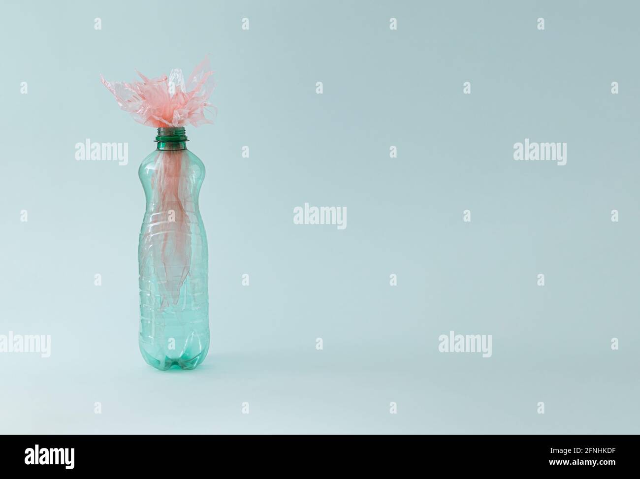 Pink plastic bags in clear green bottle for marine plastics waste ...