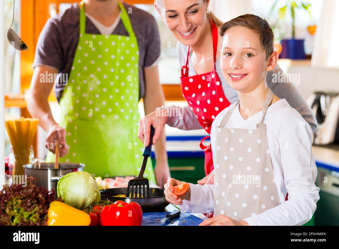 Family with Parents and children preparing healthy meal in domestic ...