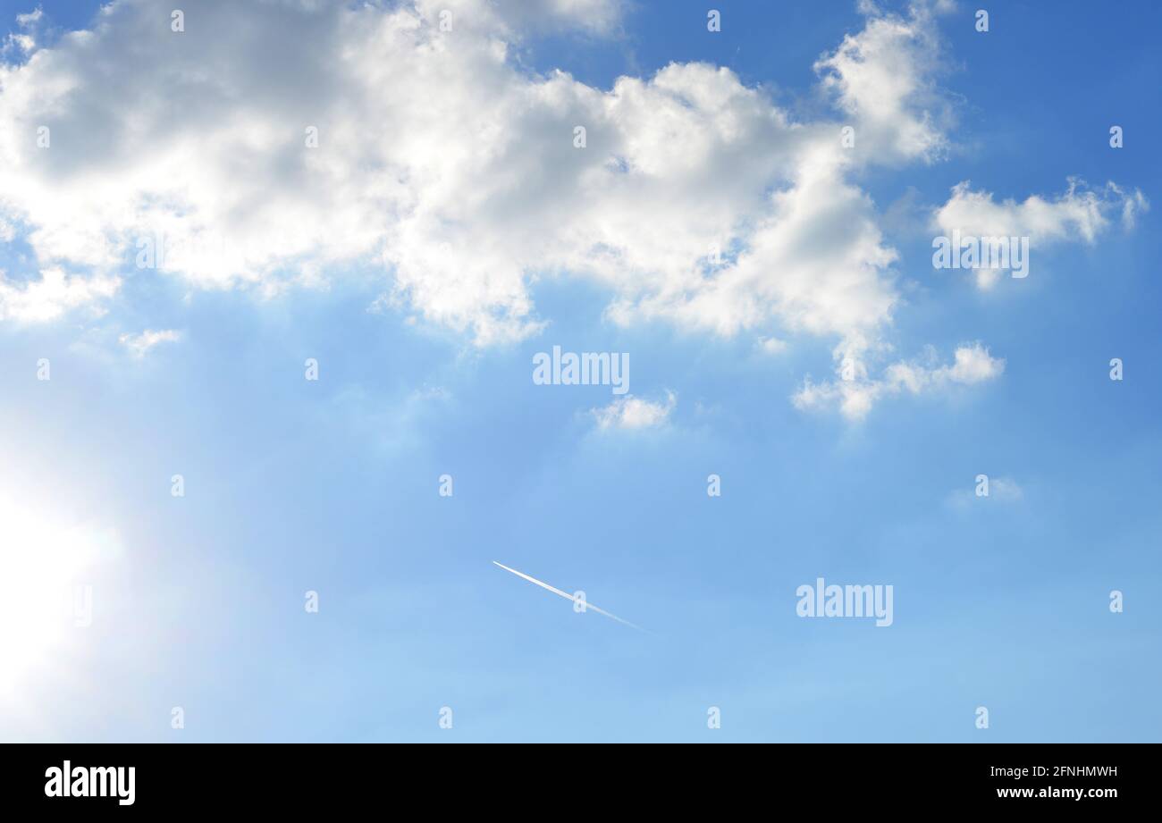 Distant airplane flying in the clouds, sky structure sun Stock Photo ...