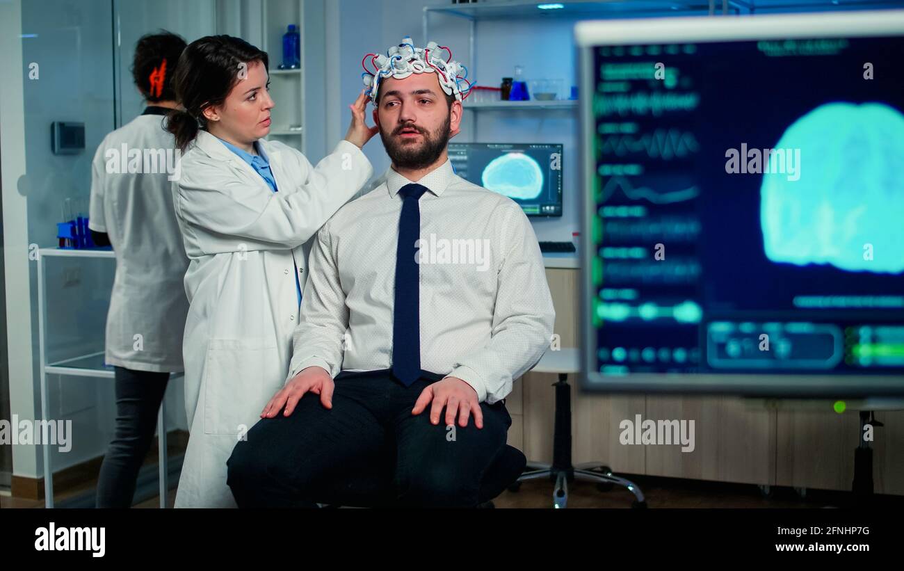 Medical researcher putting performant brainwave scanning headset ...
