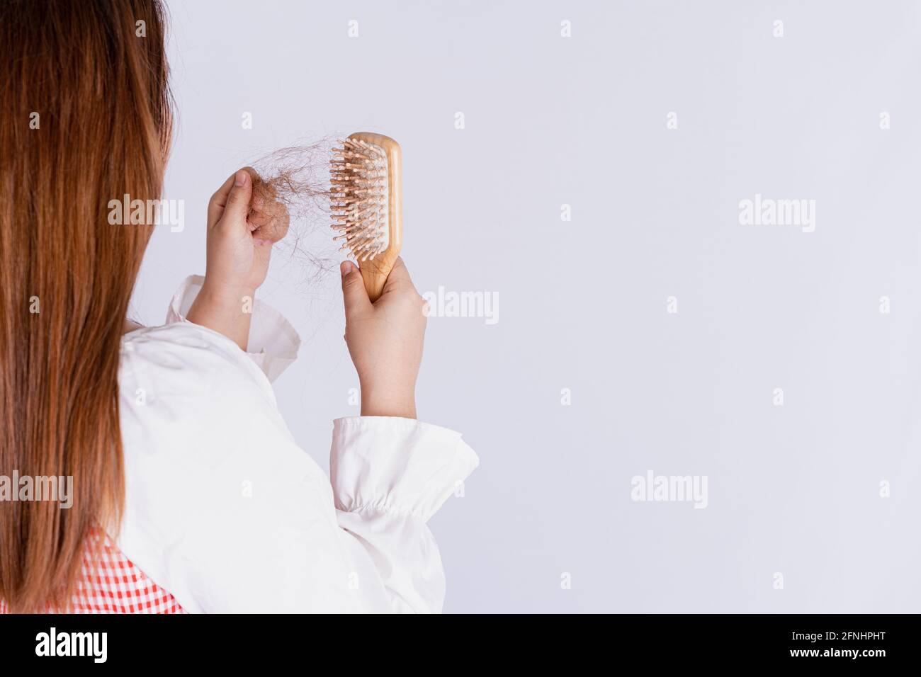 Closeup hand holding comb and hair fall problem isolated grey ...