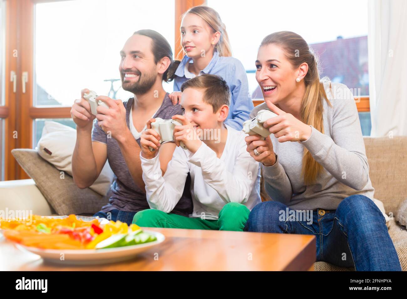 Children playing video games parents hi-res stock photography and ...