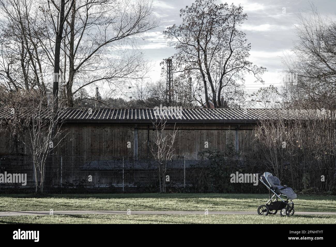 Stroller left alone on an idea in a park in front of a house Stock ...