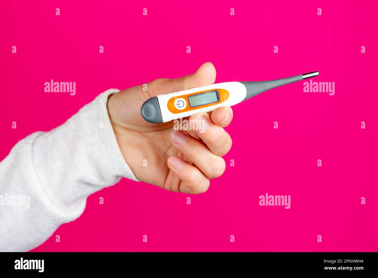 Electronic thermometer in a female hand. Thermometer for measuring body ...