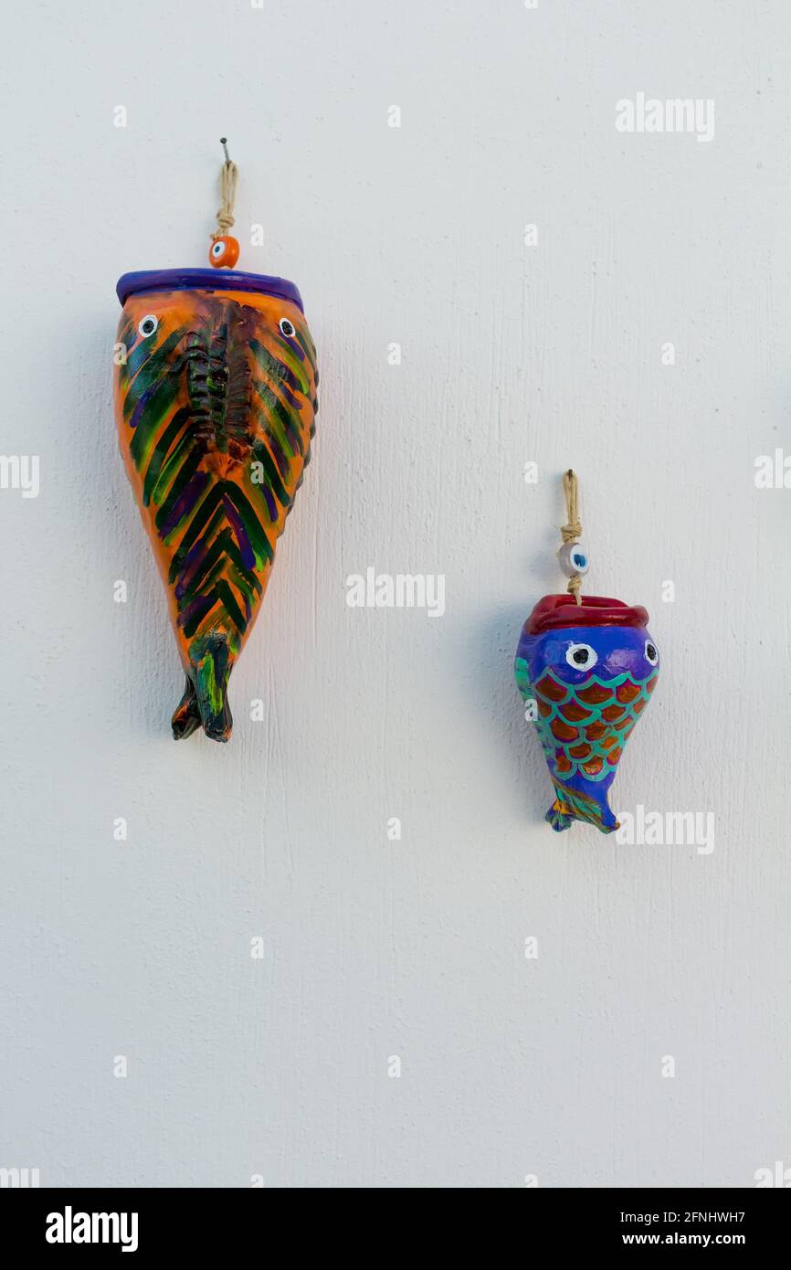 Close up view of decoration object on white plaster wall in fish forms ...