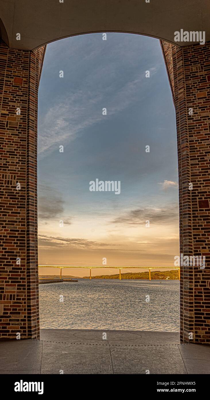 Vejle Fjord Bridge seen through an opening in the iconic brick building ...