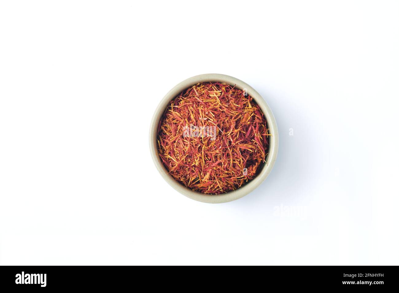 Saffron spices threads in heart shaped plate isolated on white ...