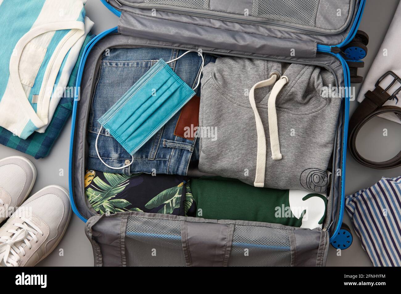 Travel suitcase with clothing outfits and accessories Stock Photo - Alamy