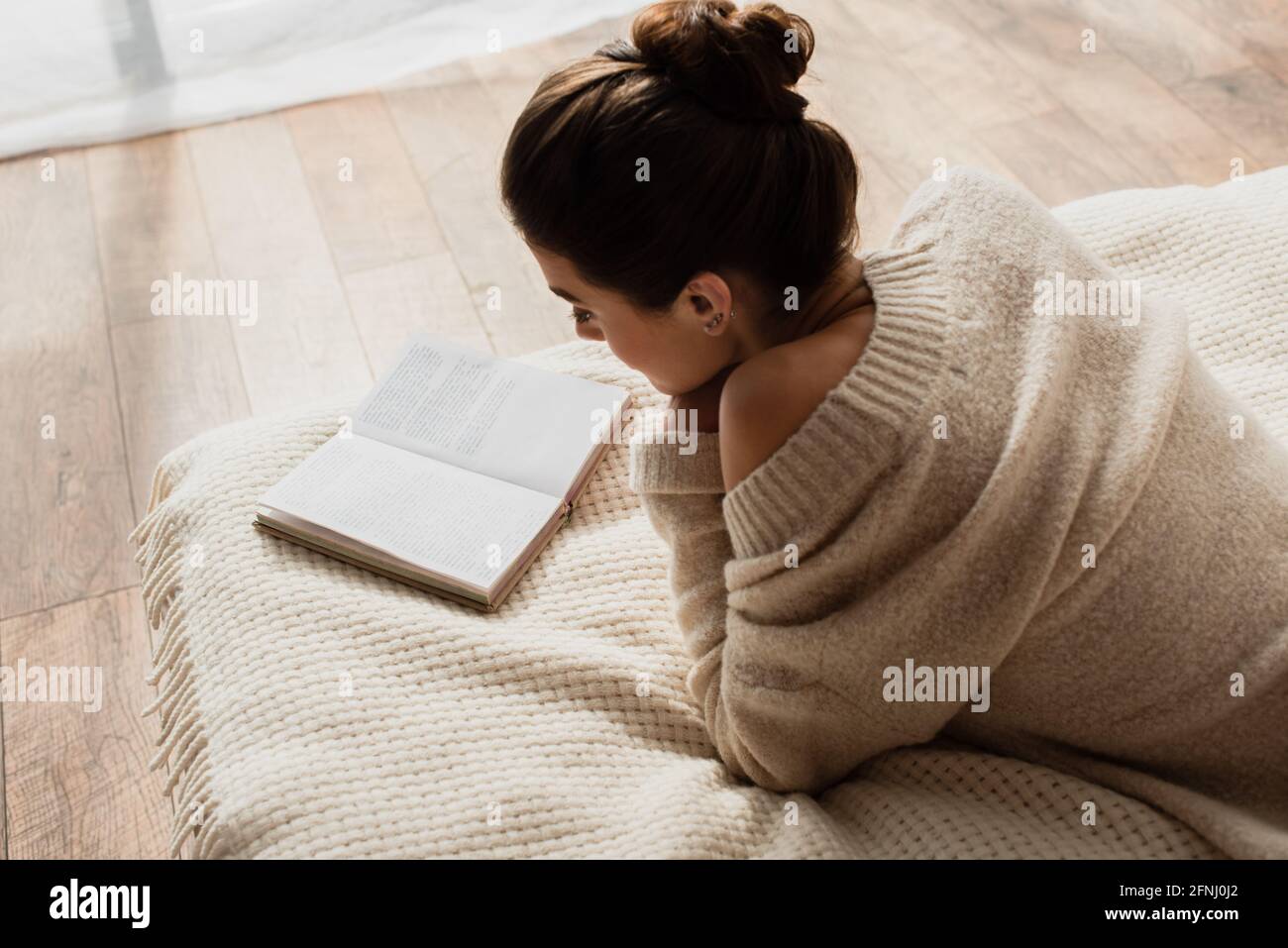 young woman reading novel while resting on bed at home Stock Photo - Alamy
