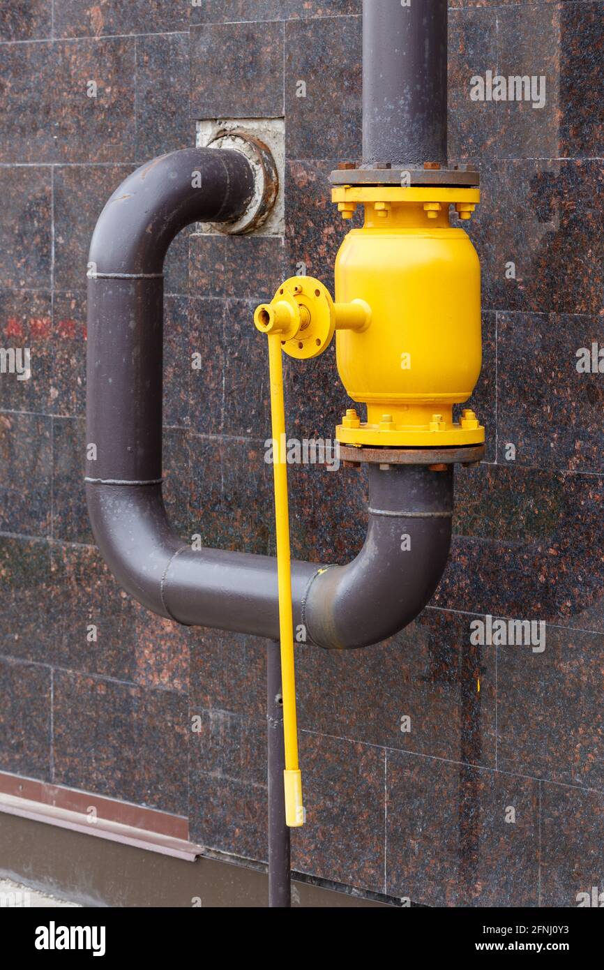 large opened yellow natural gas ball valve with long straight lever ...