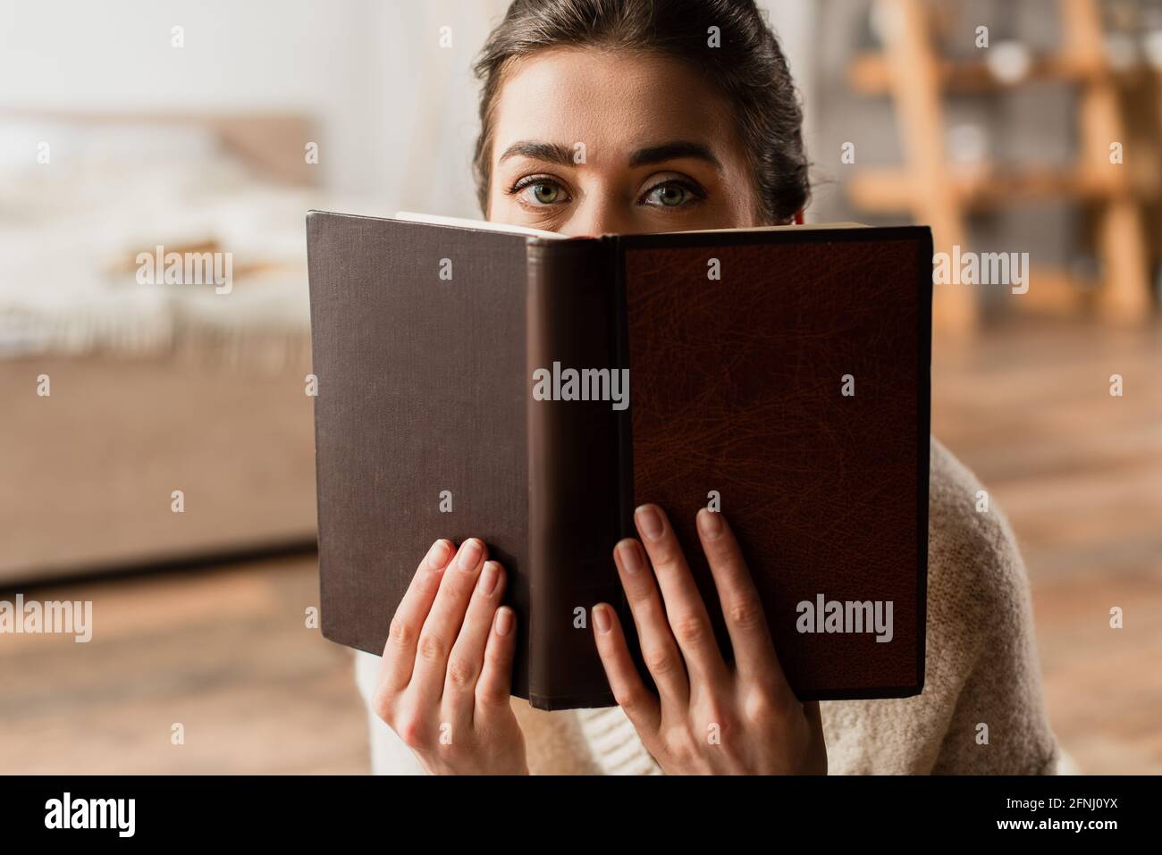 Book obscuring face hi-res stock photography and images - Alamy