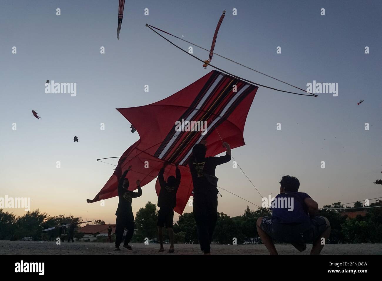 Balinese youth fly kites at Mertasari Beach, Sanur. Kite season held ...