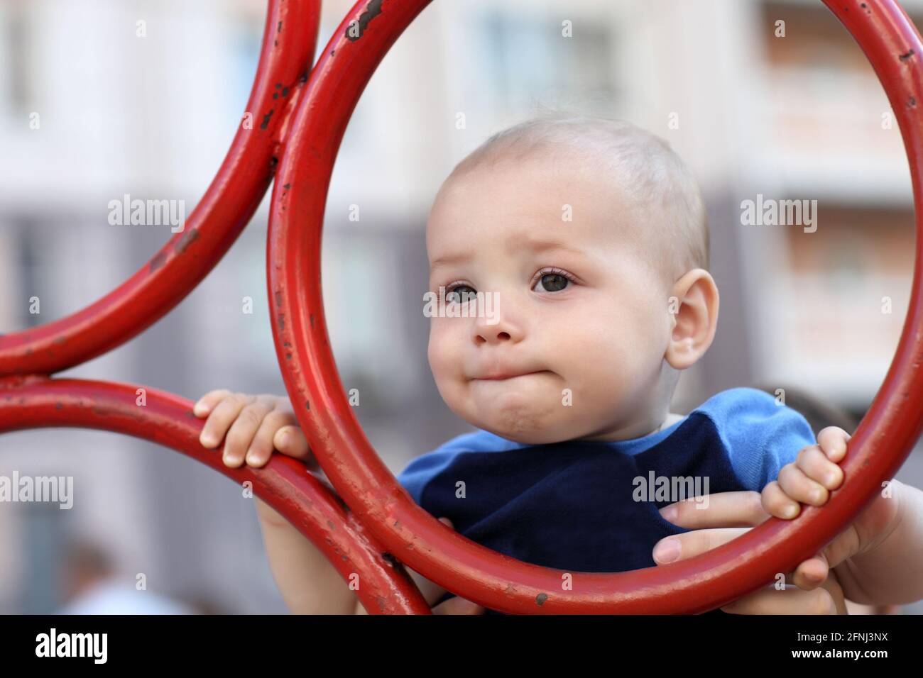 Child looking through a ring at the playground Stock Photo - Alamy