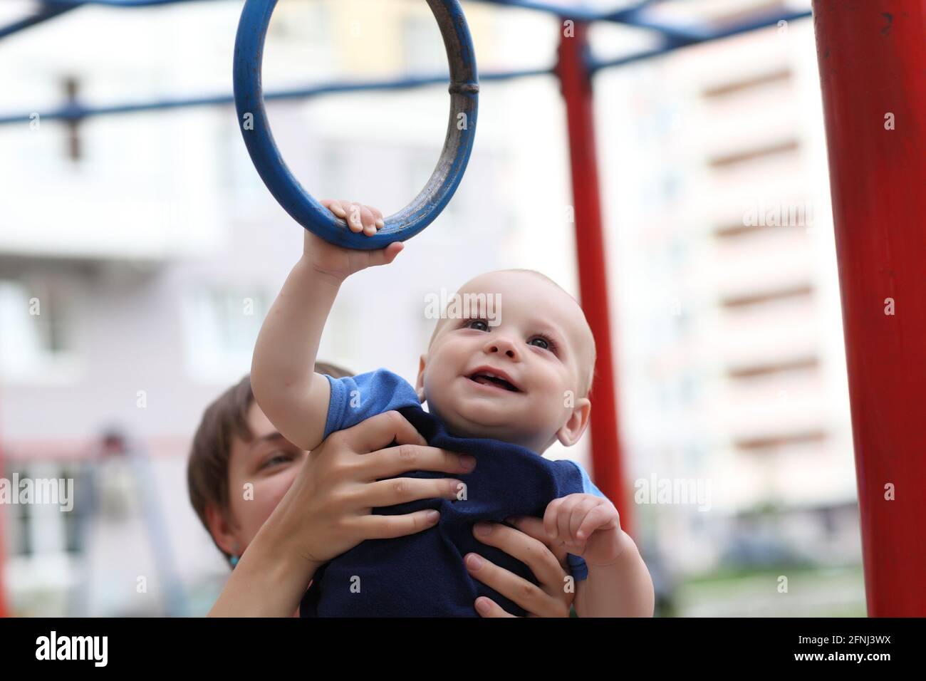 Little child playing with rings at outdoor playground Stock Photo - Alamy