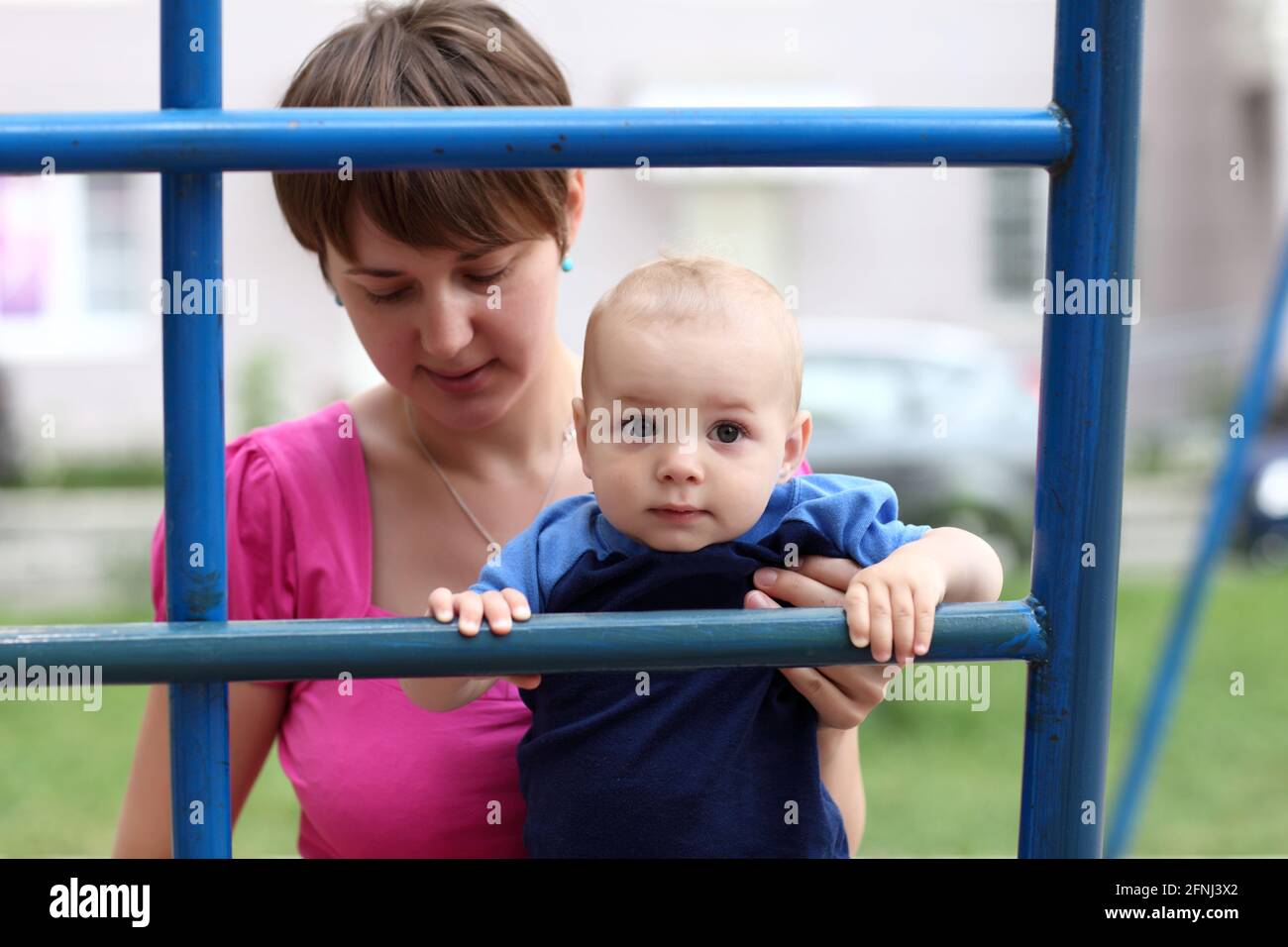 Portrait of baby with his mother on ladder at playground Stock Photo ...