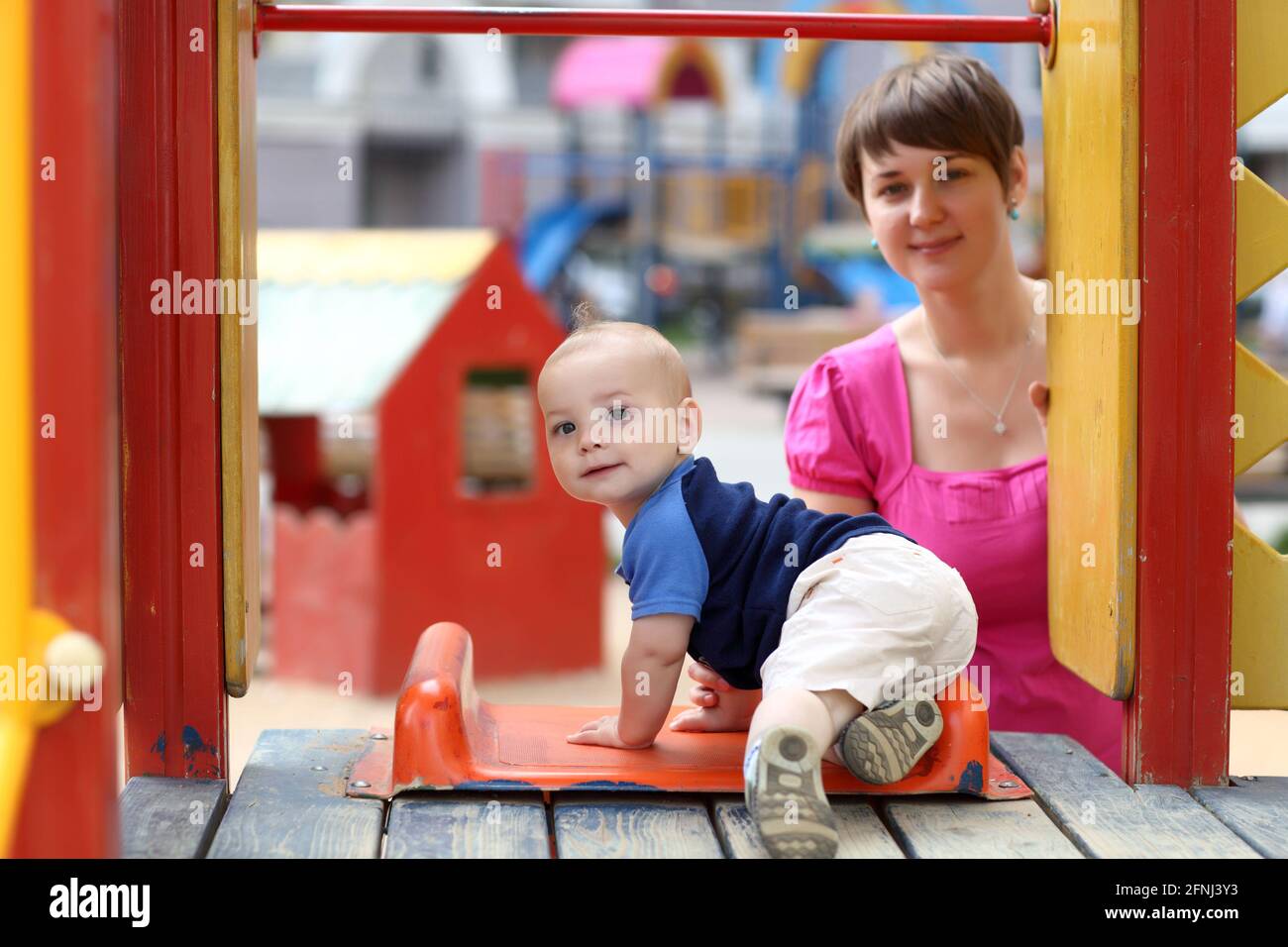 Little baby is going to sliding on a slide Stock Photo - Alamy