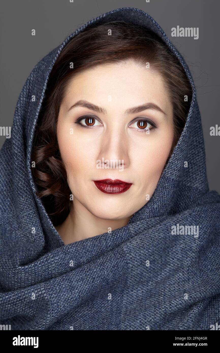 Beauty portrait of brunette woman dressed in dark blue scarf. Female ...