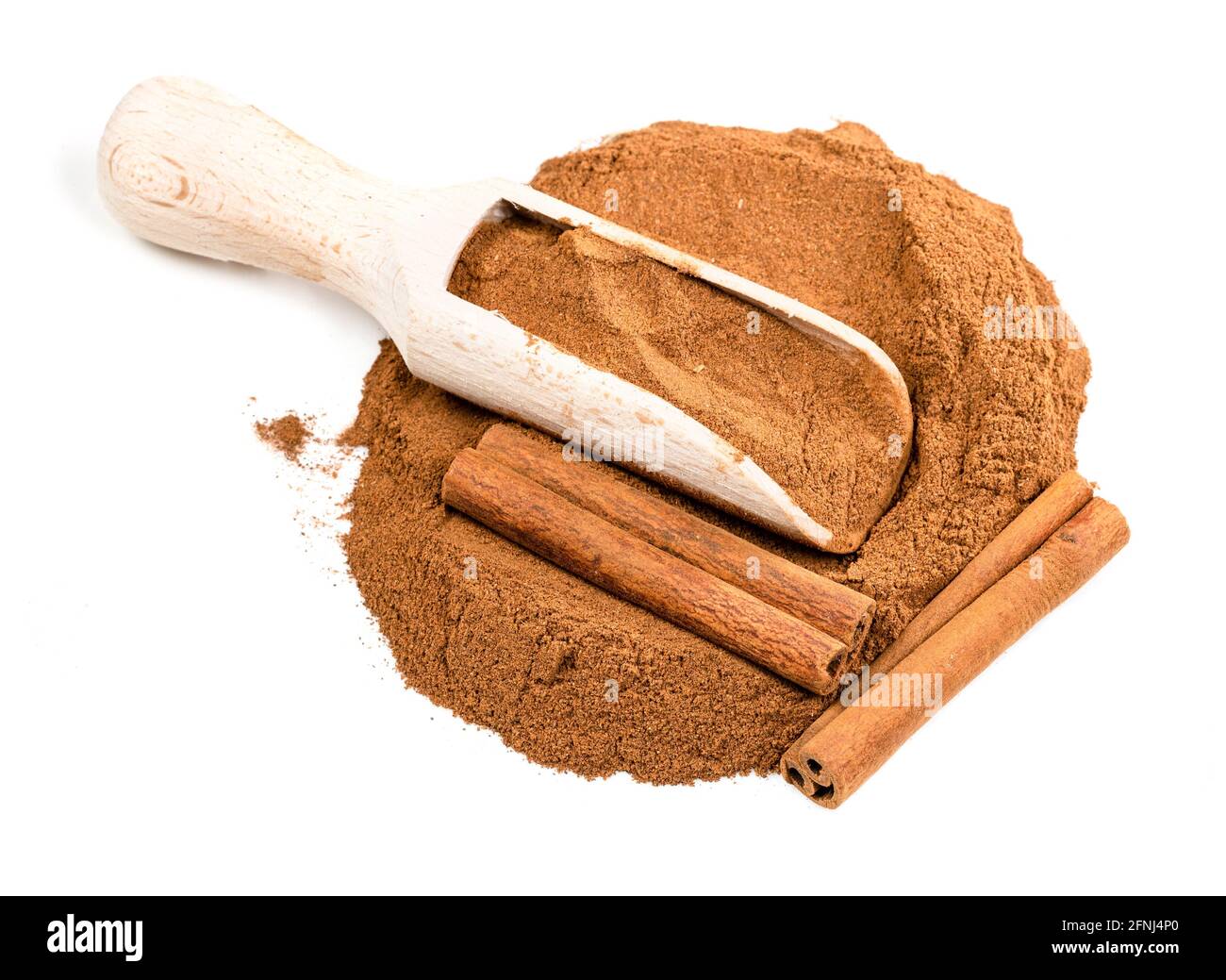 wooden scoop on pile of cassia bark and cinnamon powder on white ...