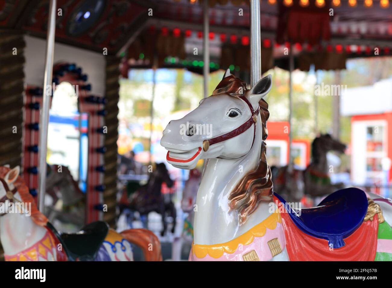 The element of horse carousel on the playground Stock Photo - Alamy