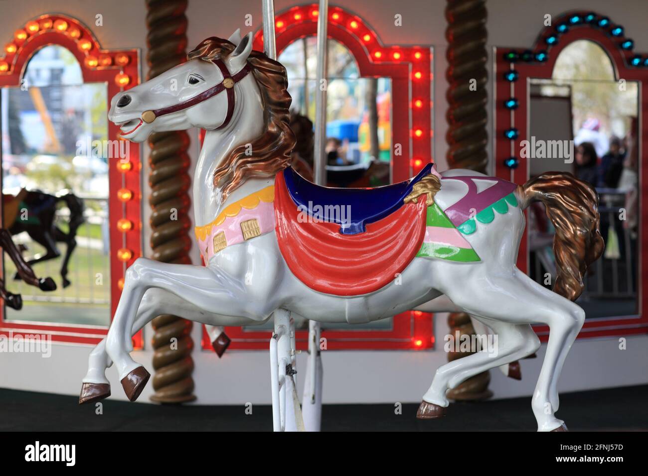 The horse carousel on the playground in summer Stock Photo - Alamy
